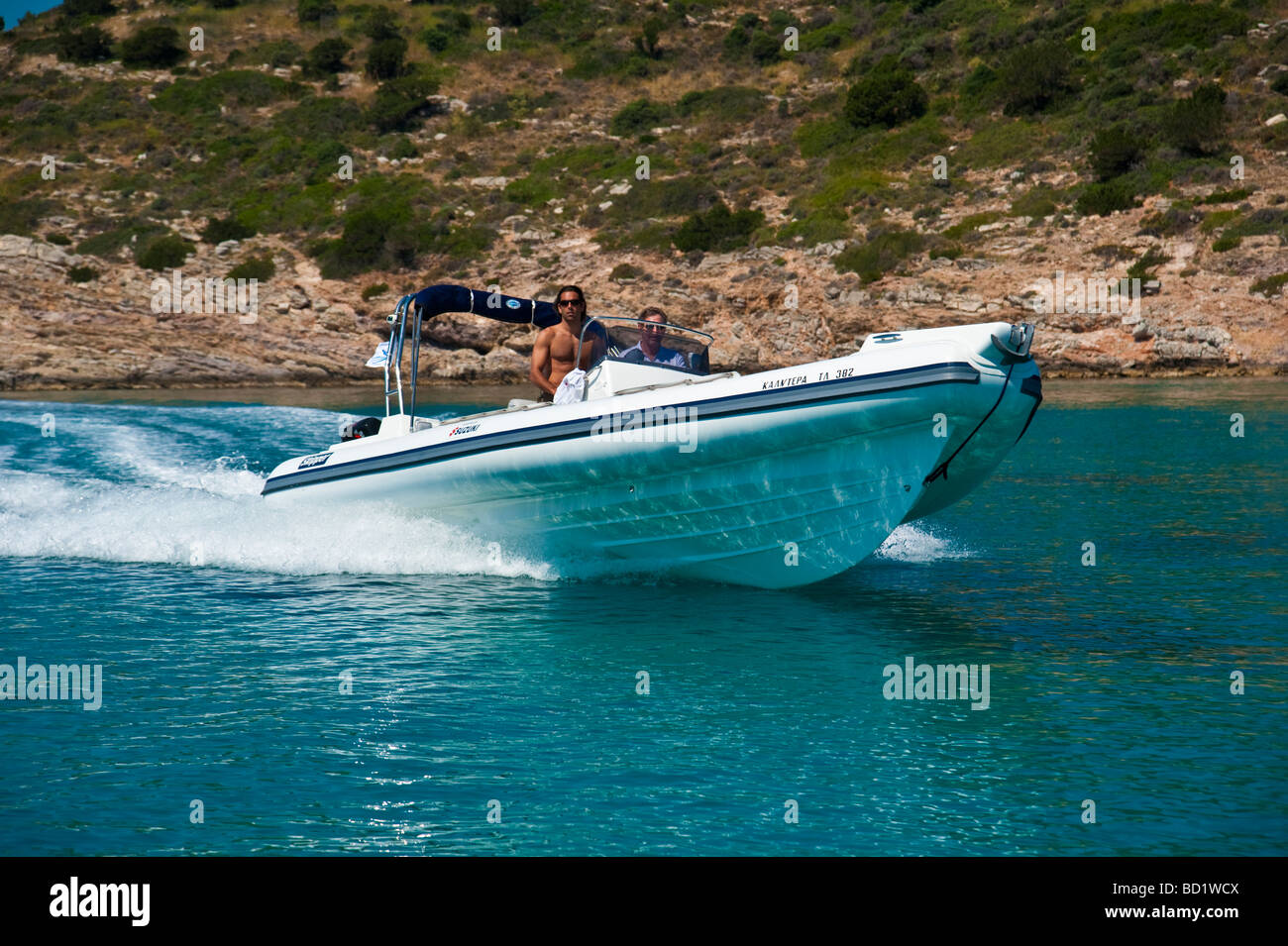 Men in fast white inflatable boat near the coastline Stock Photo - Alamy