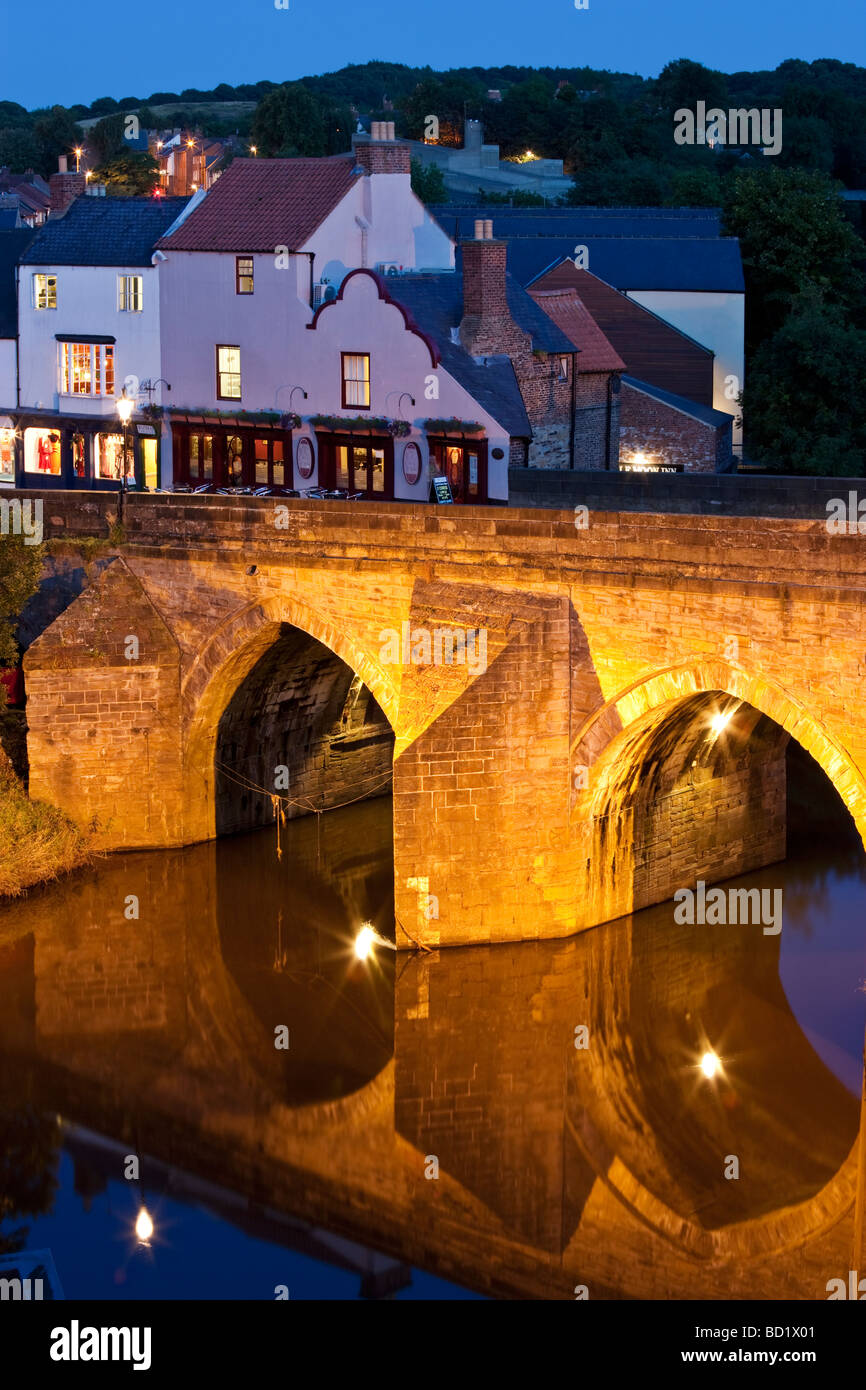 The arches of the Elvet Bridge floodlit at night on the River Wear in ...