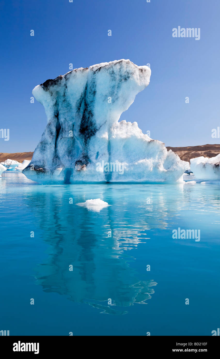 A glacial iceberg and its symmetrical reflection floating on the ...