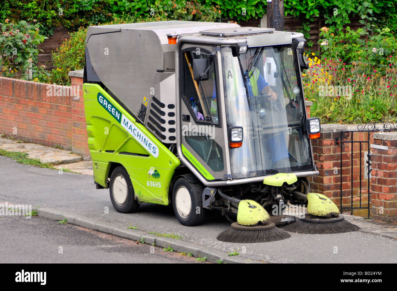 Mechanical road and pavement sweeper at work Stock Photo - Alamy