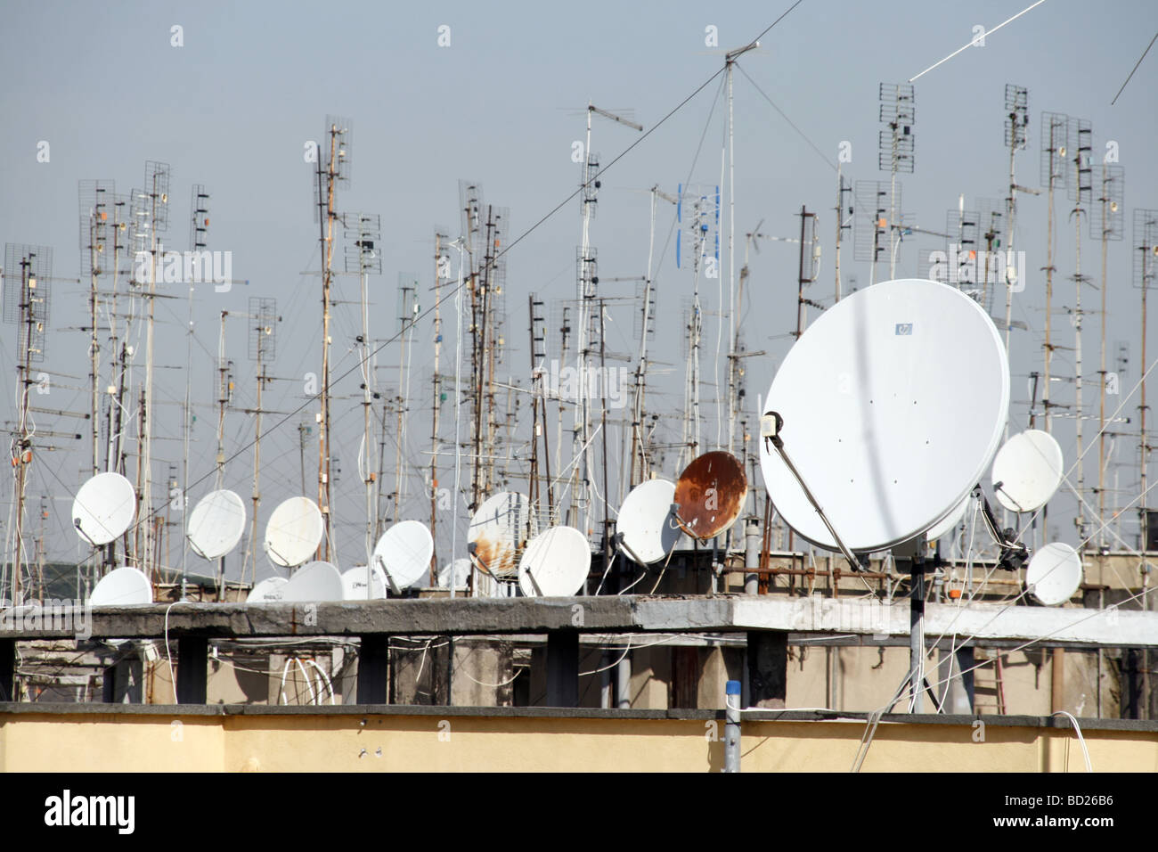 many tv aerials and satellite dishes on rooftops Stock Photo - Alamy