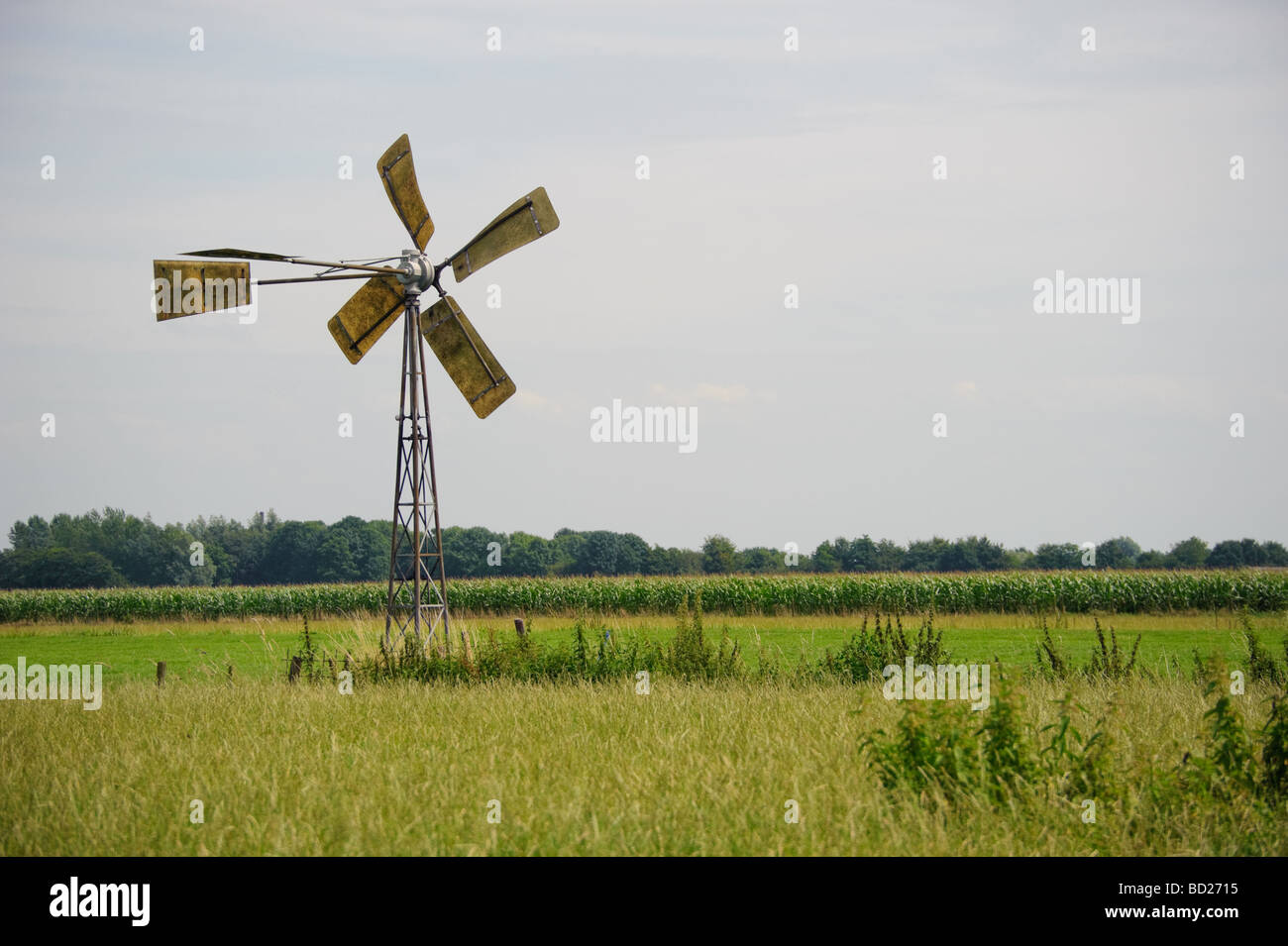 Windmill on a pole in a green meadow Stock Photo - Alamy