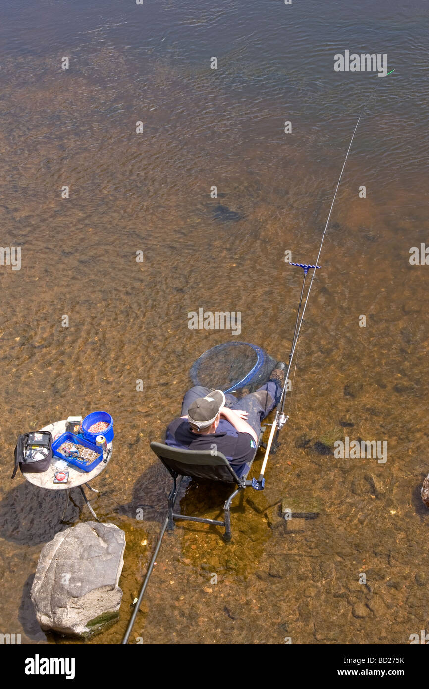 relaxed angler fishing in a river Stock Photo - Alamy
