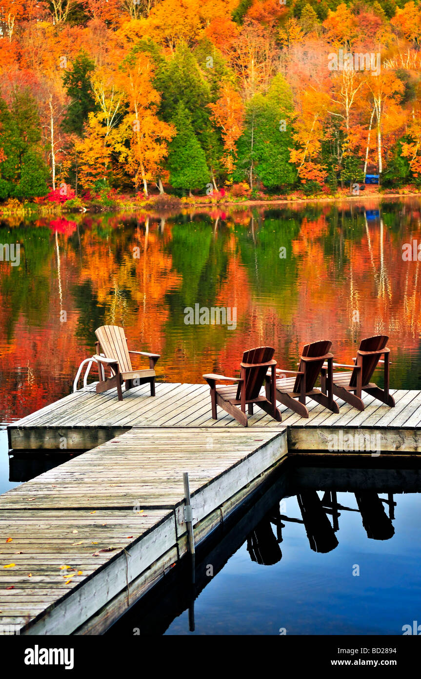 Wooden dock with chairs on calm fall lake Stock Photo - Alamy
