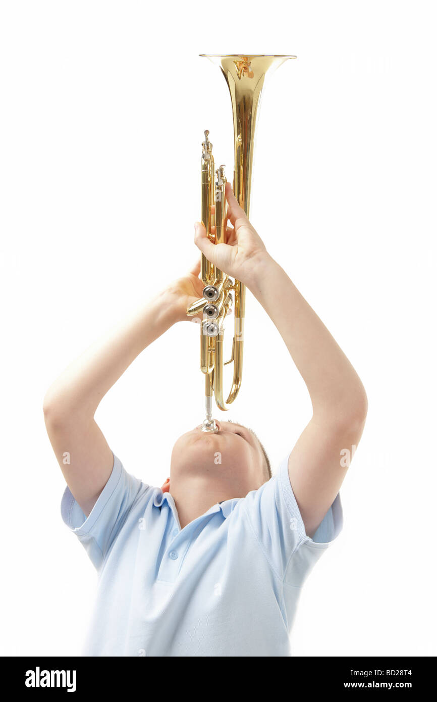 young boy blowing into a trumpet against white background Stock Photo ...