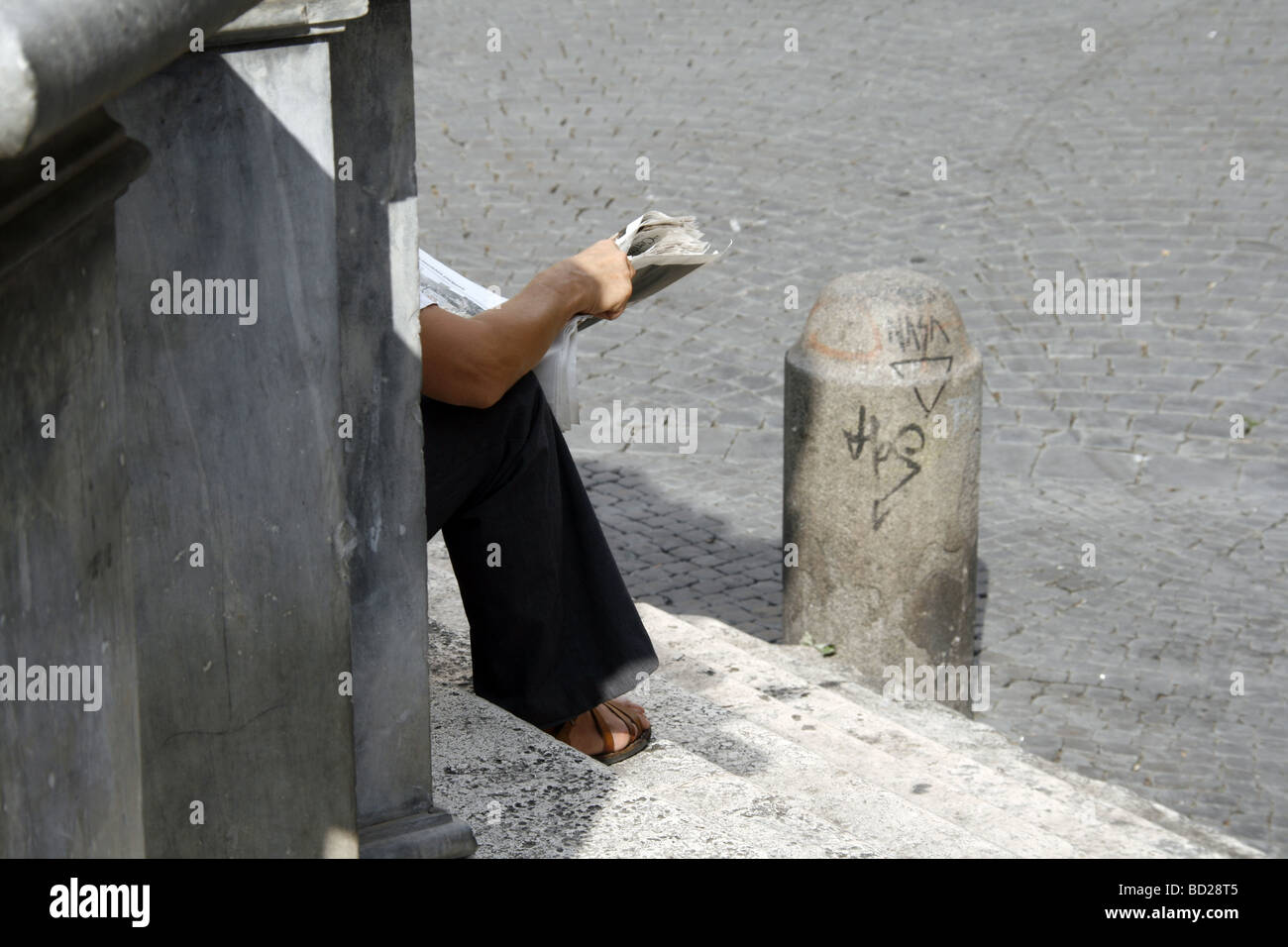 person reading newspaper on steps in rome italy Stock Photo - Alamy
