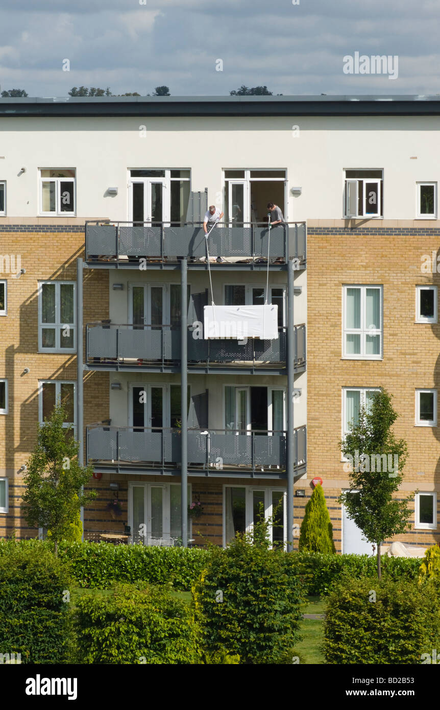 Moving furniture externally from a top floor flat using ropes Stock ...