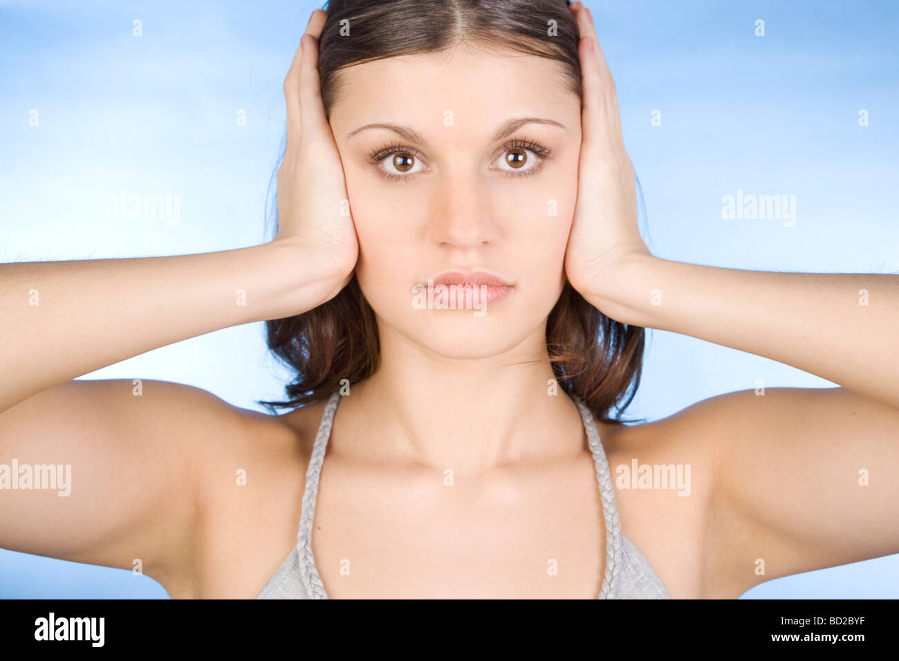 Woman covering ears Stock Photo - Alamy