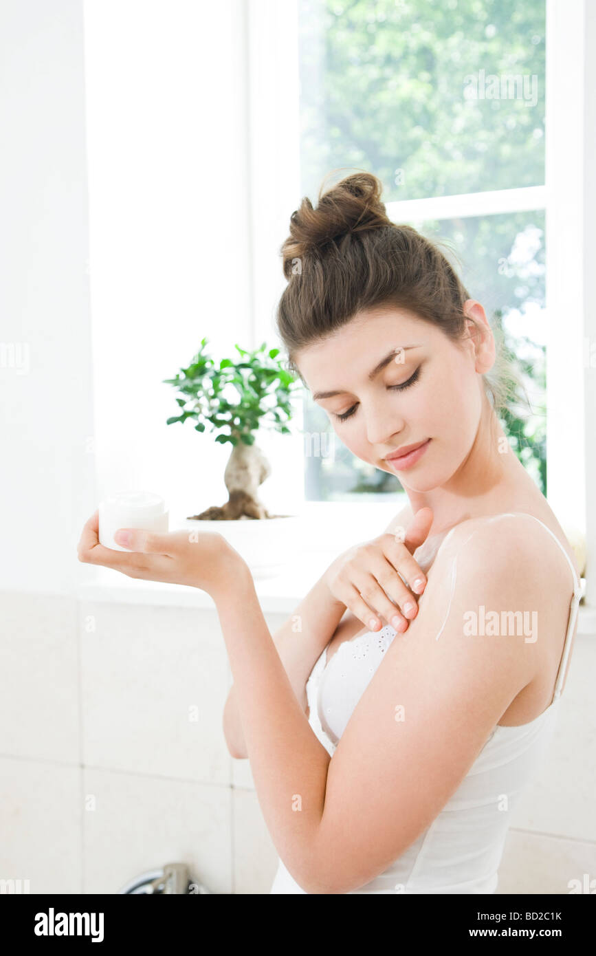 Woman applying cream on arm Stock Photo - Alamy