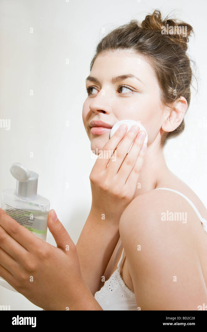 Woman applying face tonic Stock Photo - Alamy