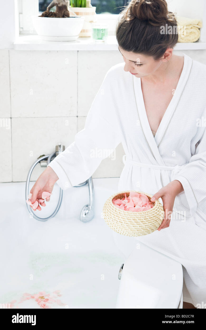 Woman throwing rose petals into bath Stock Photo - Alamy