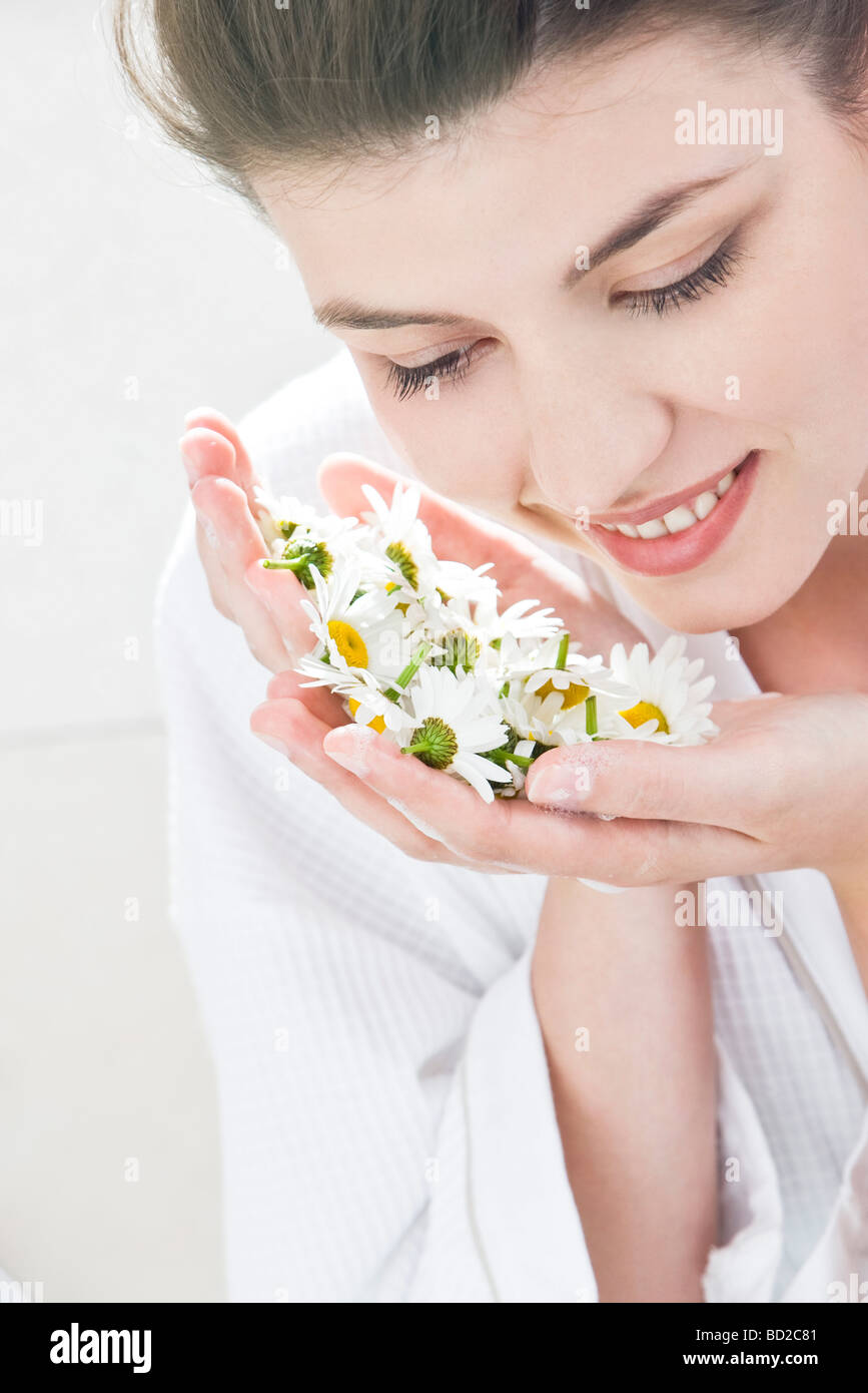 Woman with chamomile flowers Stock Photo - Alamy