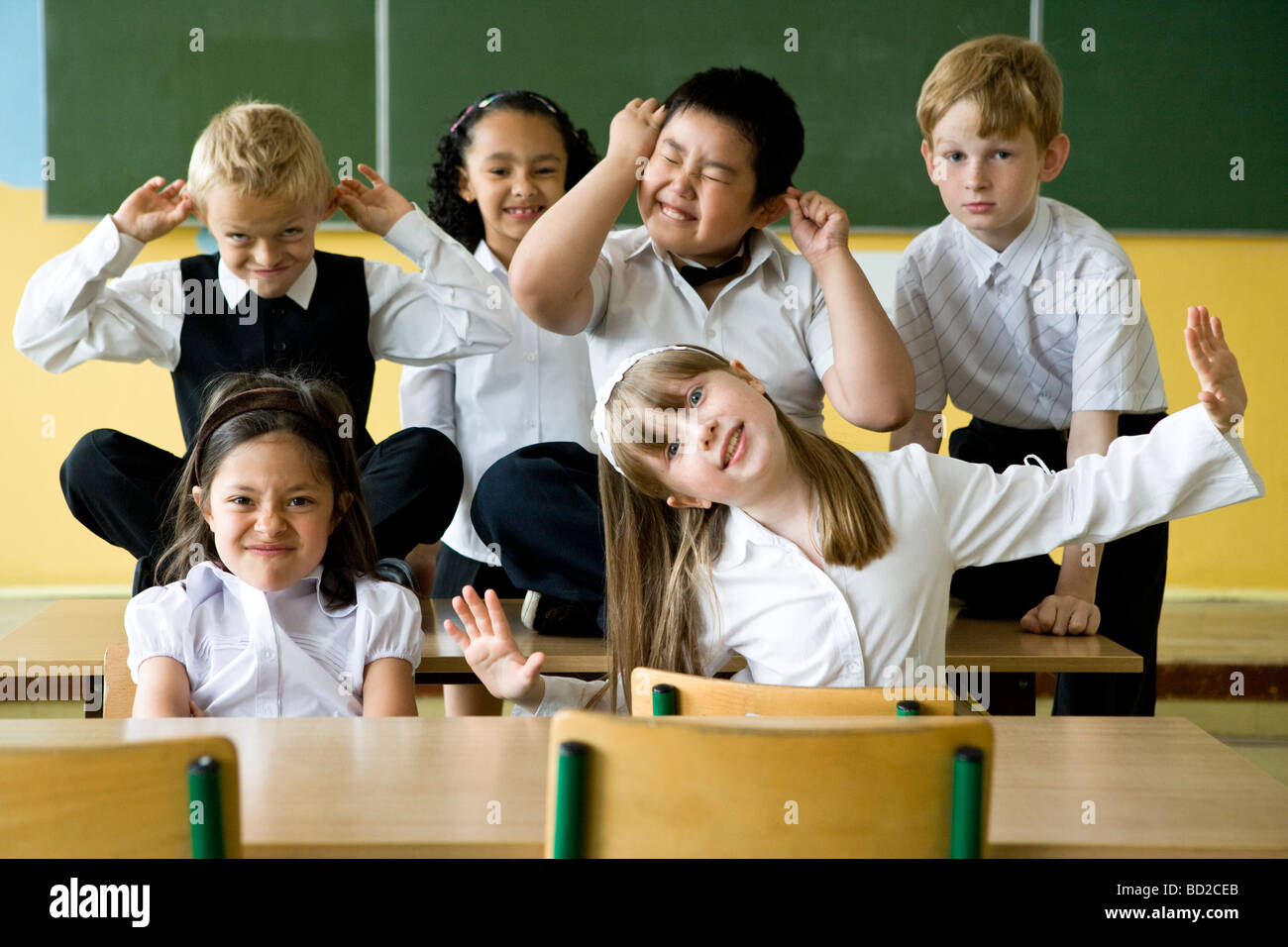Happy children in classroom Stock Photo - Alamy