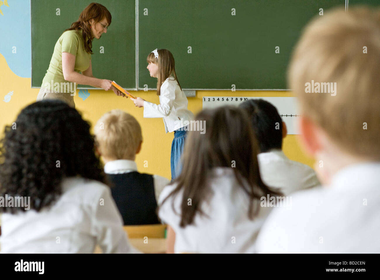 Teacher giving school reports to children Stock Photo - Alamy