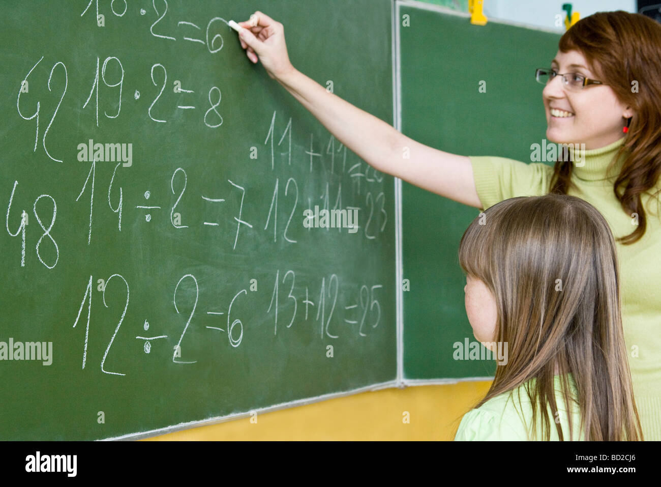 Teacher writing on blackboard Stock Photo - Alamy Teacher writing on blackboard Stock Photo - Alamy