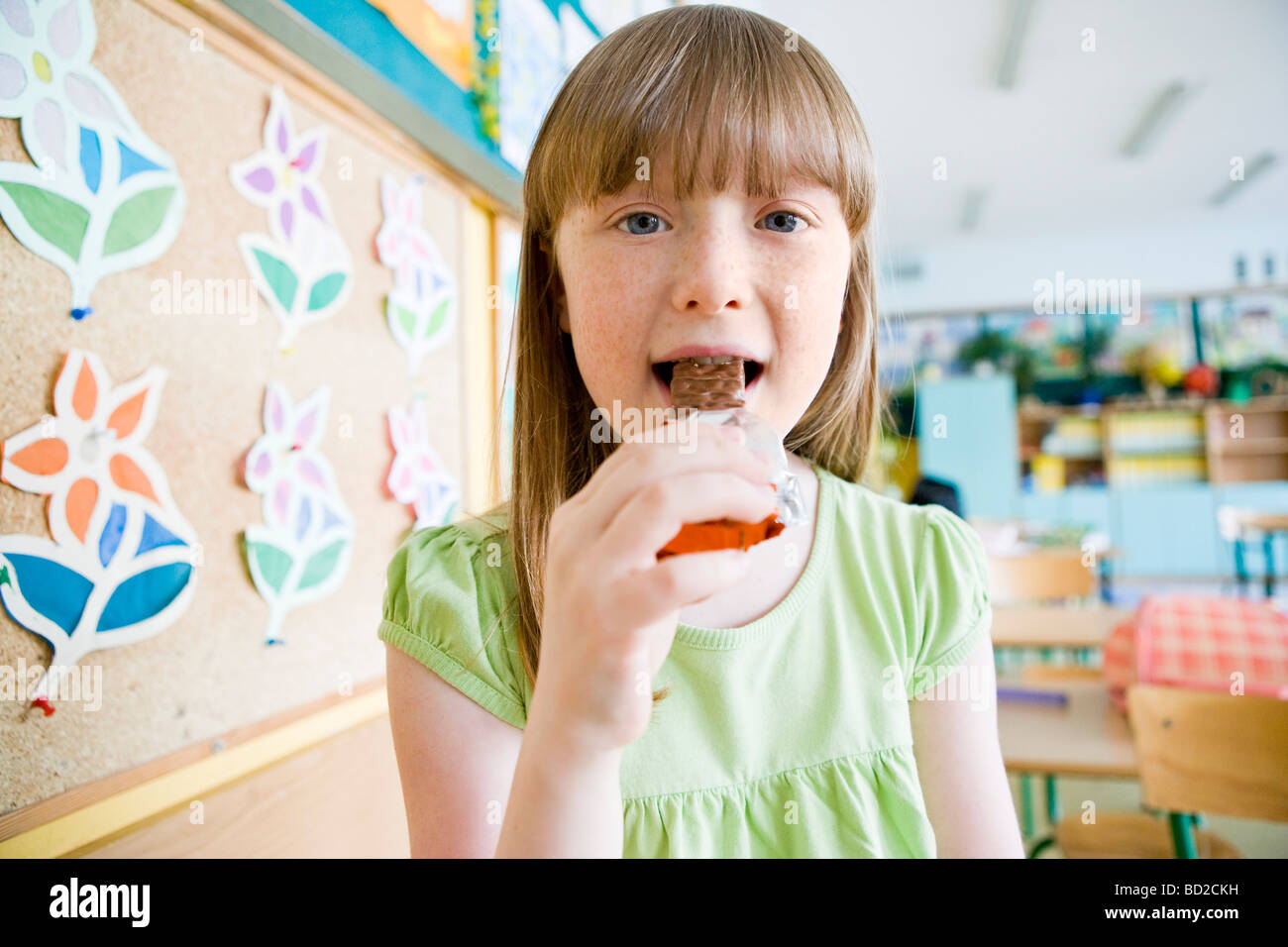 girl eating chocolate bar at school Stock Photo - Alamy