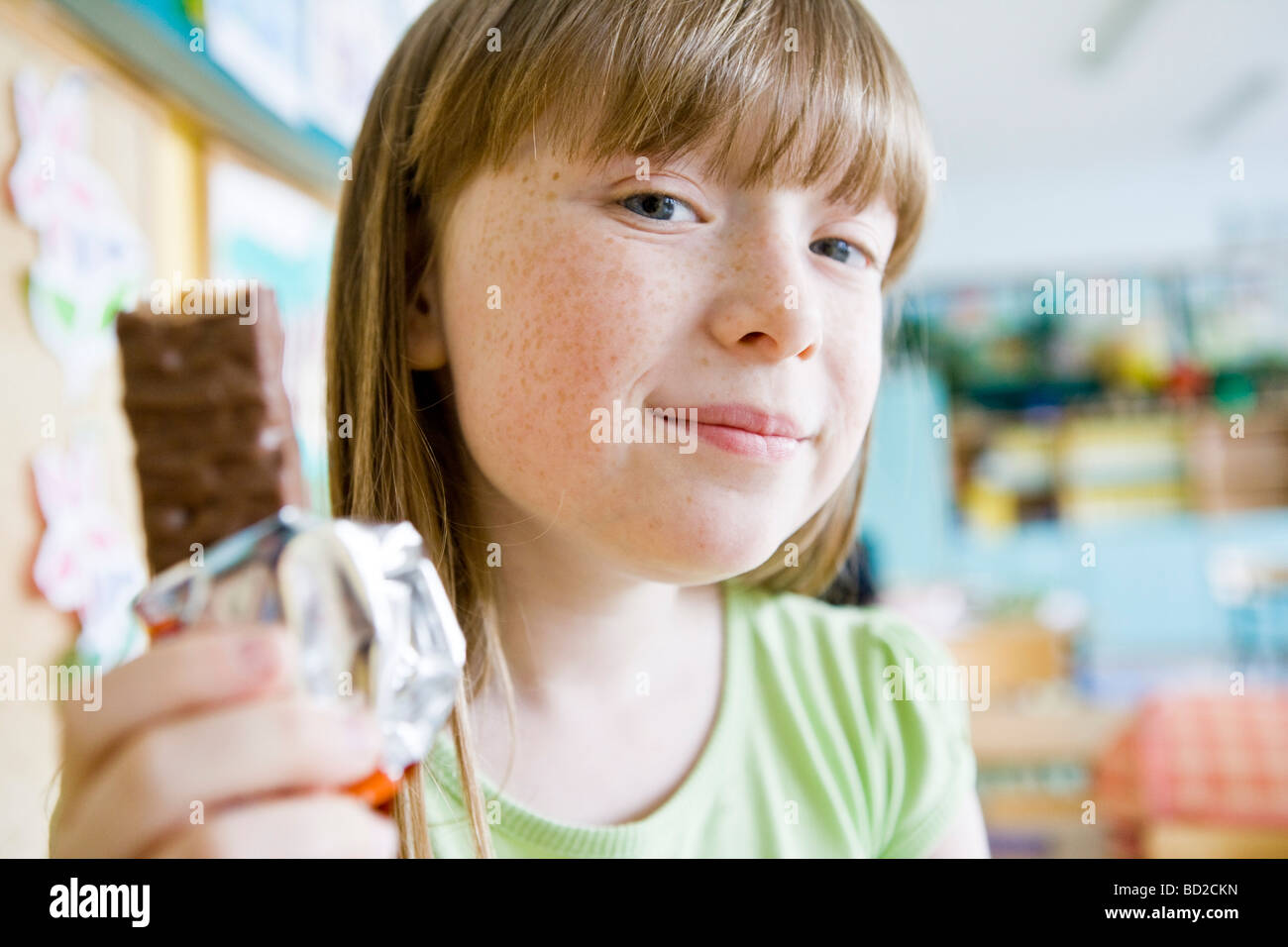girl eating chocolate bar at school Stock Photo - Alamy