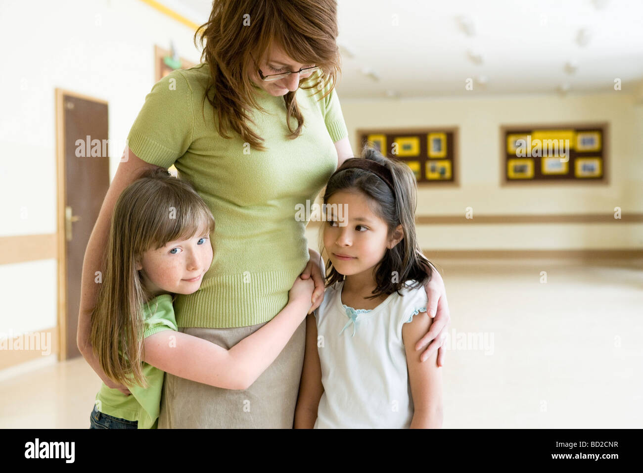 students hugging a teacher Stock Photo - Alamy
