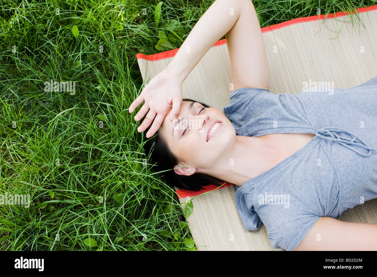 woman relaxing on grass Stock Photo - Alamy