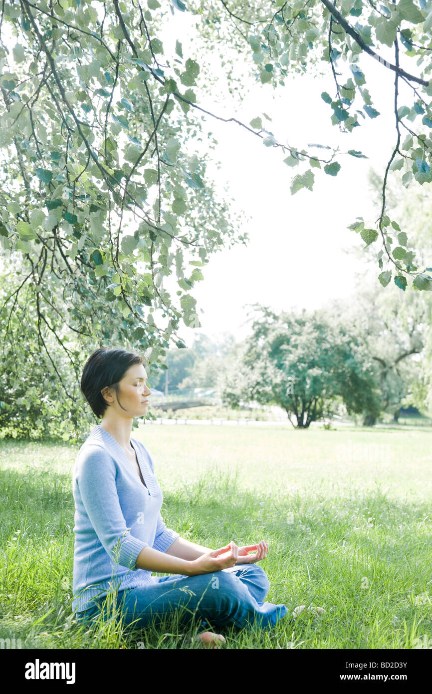woman doing meditation in park Stock Photo - Alamy