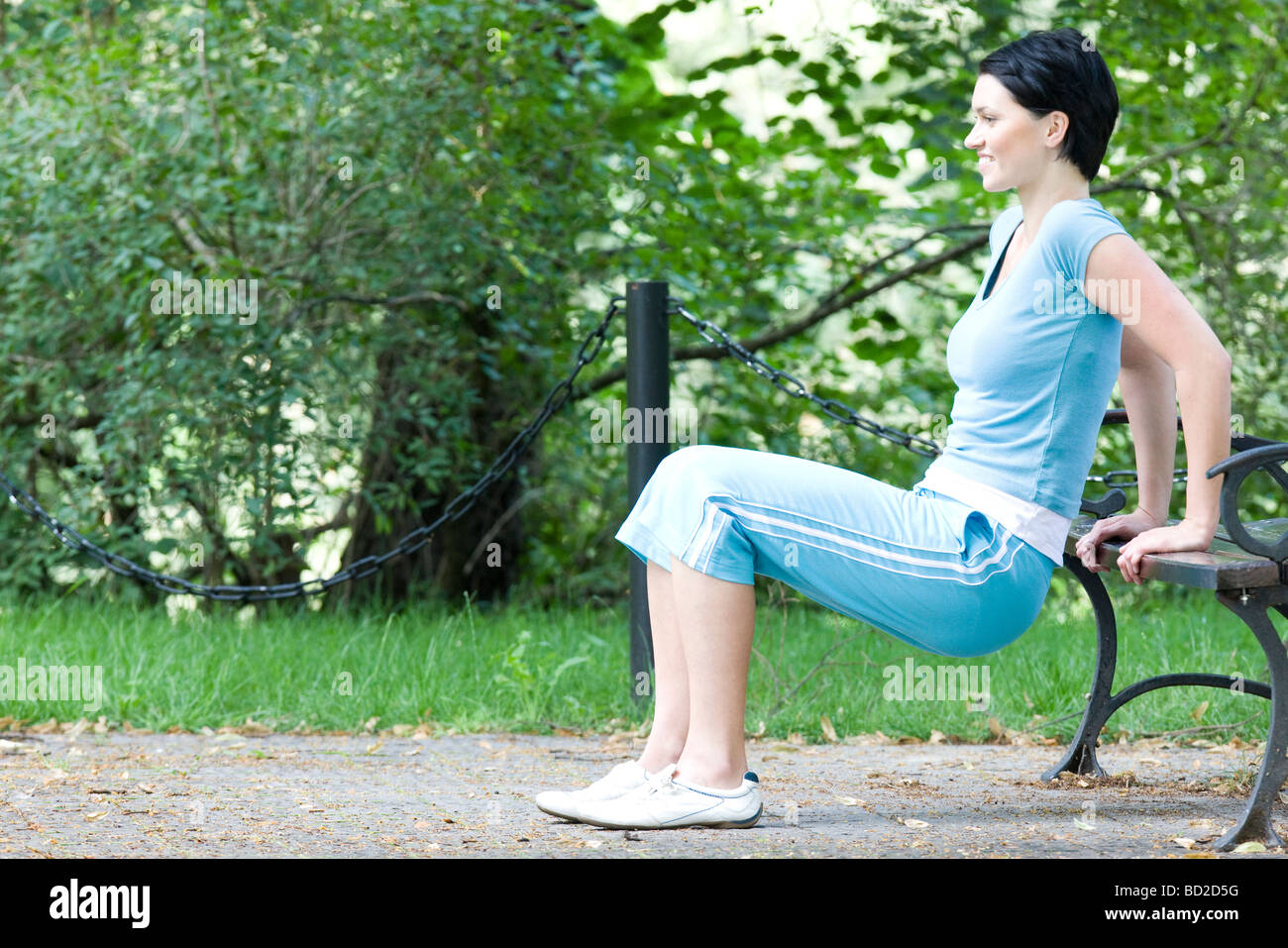 Woman exercising in park Stock Photo - Alamy