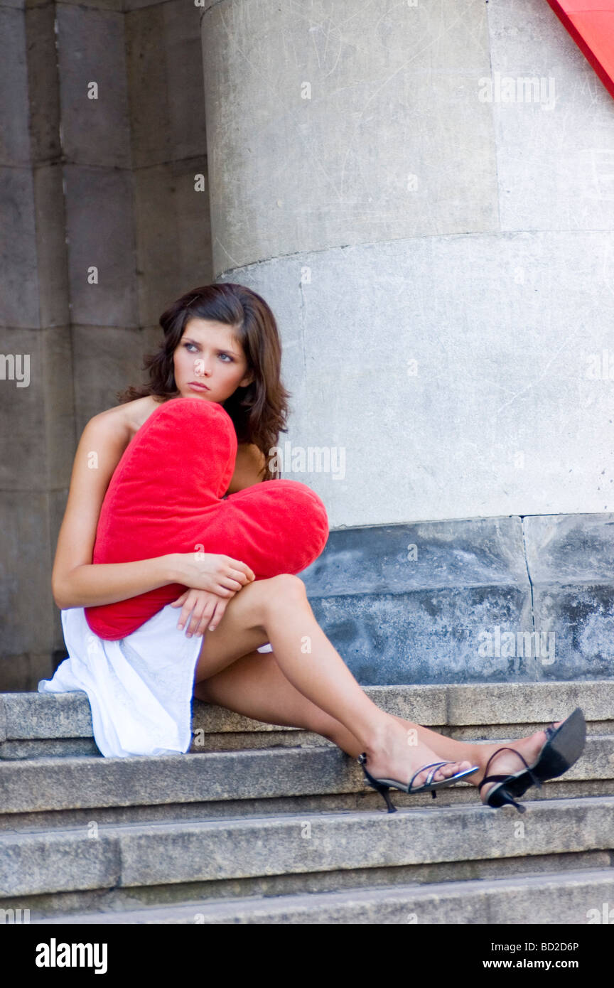 Sad woman sitting on stairs Stock Photo - Alamy