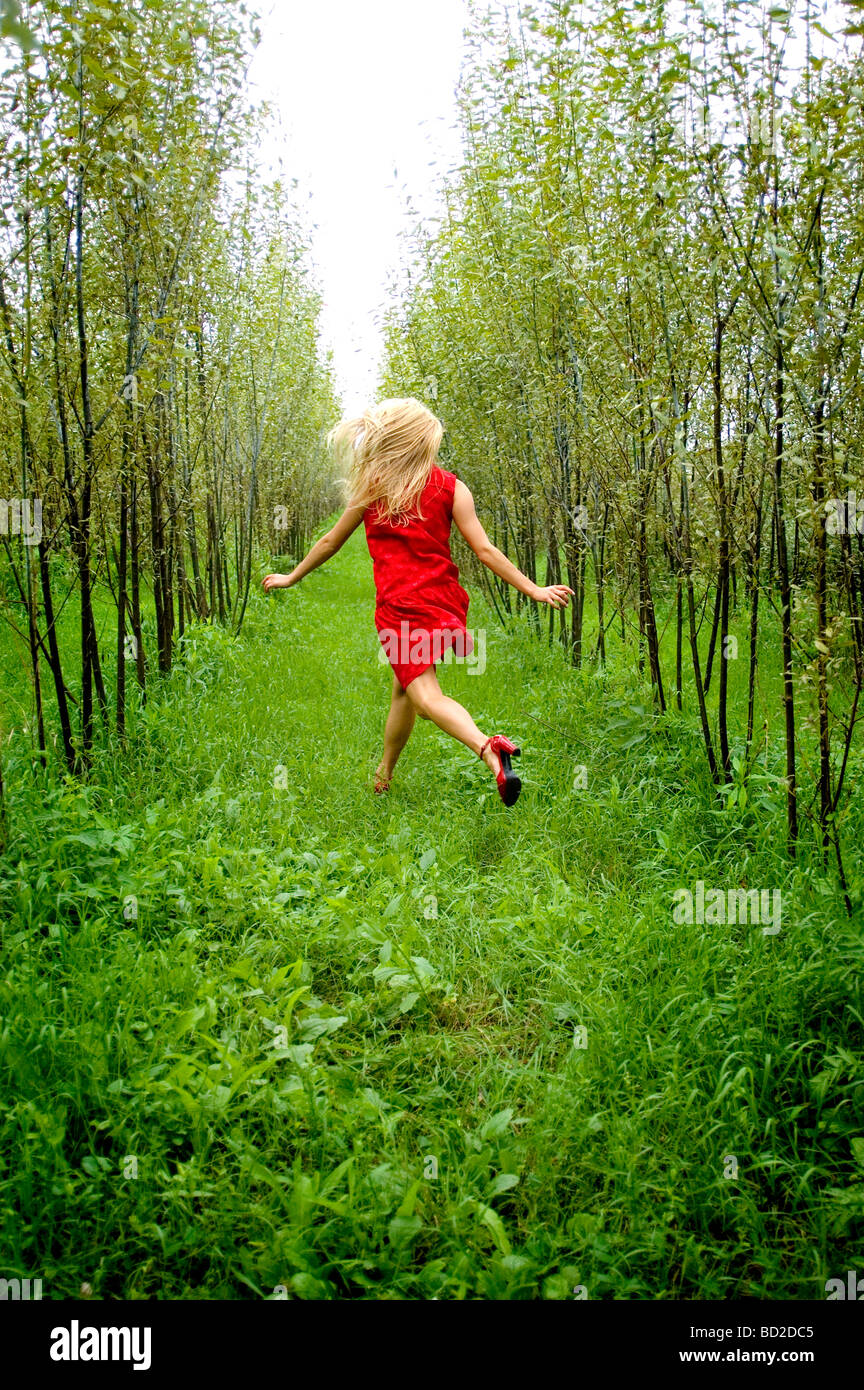 Young woman running in forest Stock Photo - Alamy