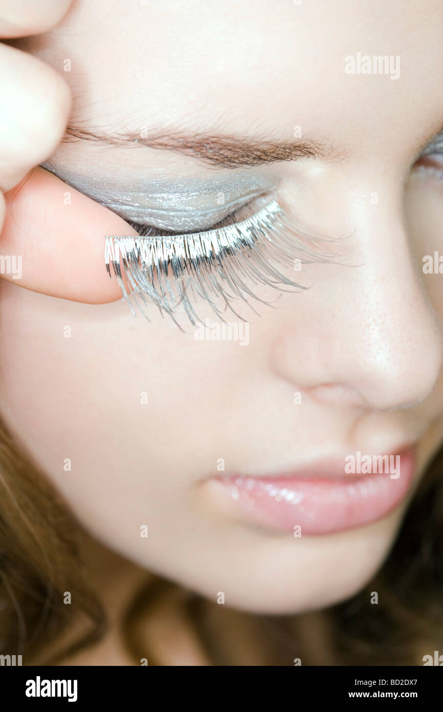 Young woman applying fake eyelashes Stock Photo - Alamy