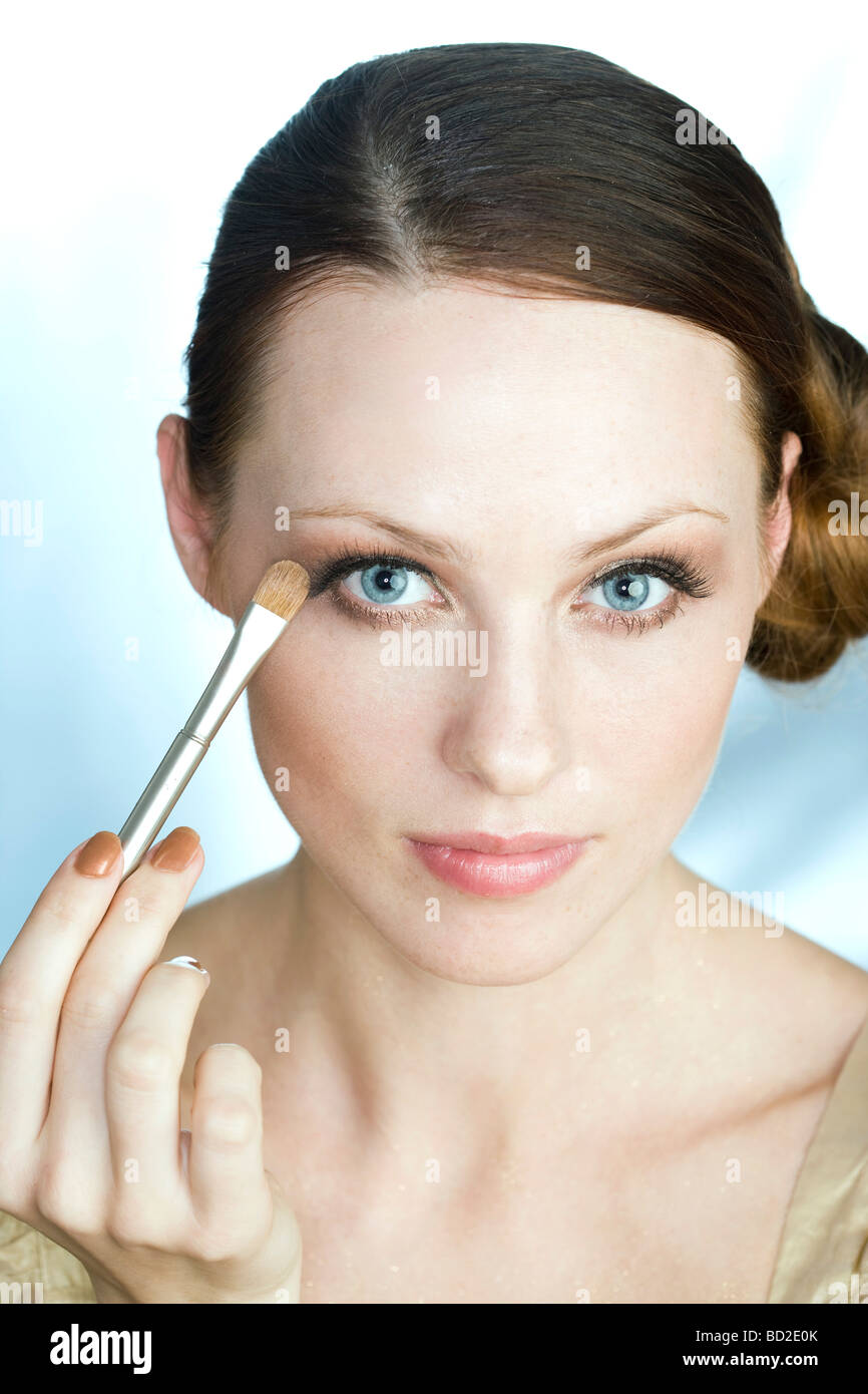 Woman applying eyeshadow Stock Photo - Alamy