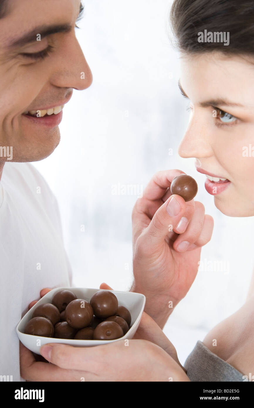 Couple feeding chocolates hi-res stock photography and images - Alamy