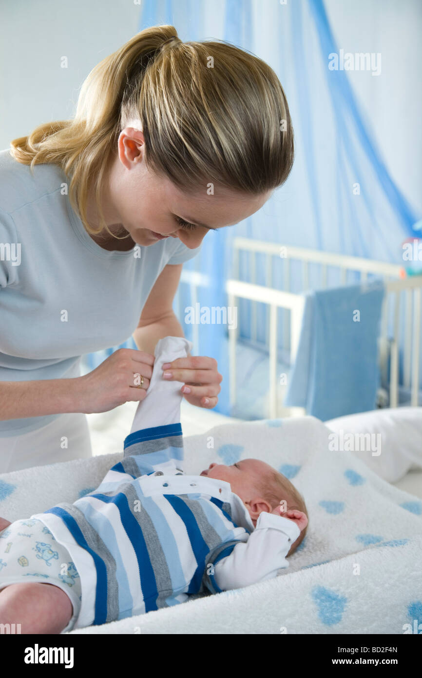 mum dressing up infant Stock Photo - Alamy