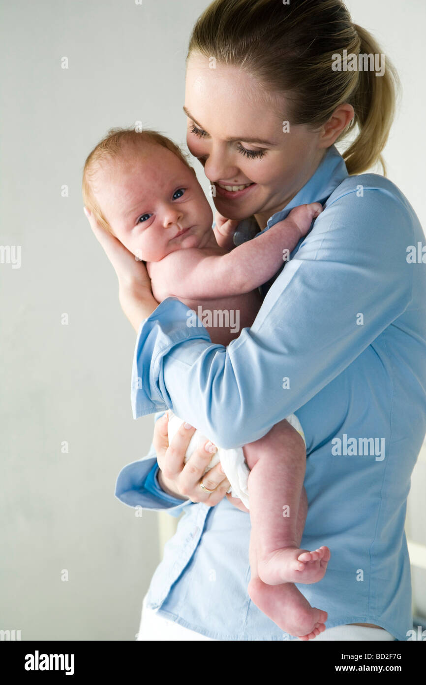 Months carrying hug hugging infant hi-res stock photography and images ...