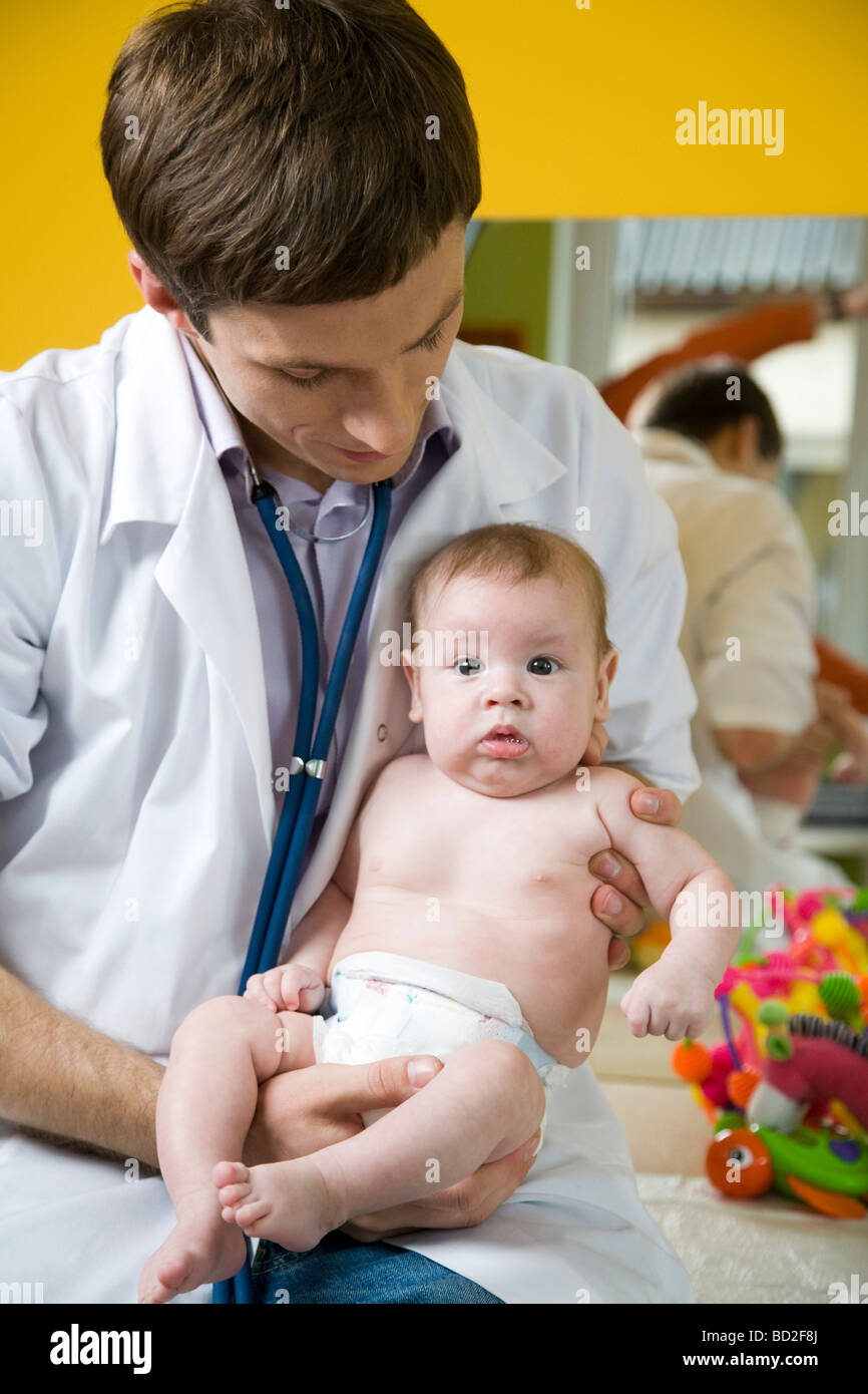 doctor examining infant Stock Photo - Alamy