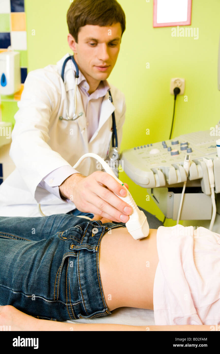Doctor examining stomach girl hi-res stock photography and images - Alamy