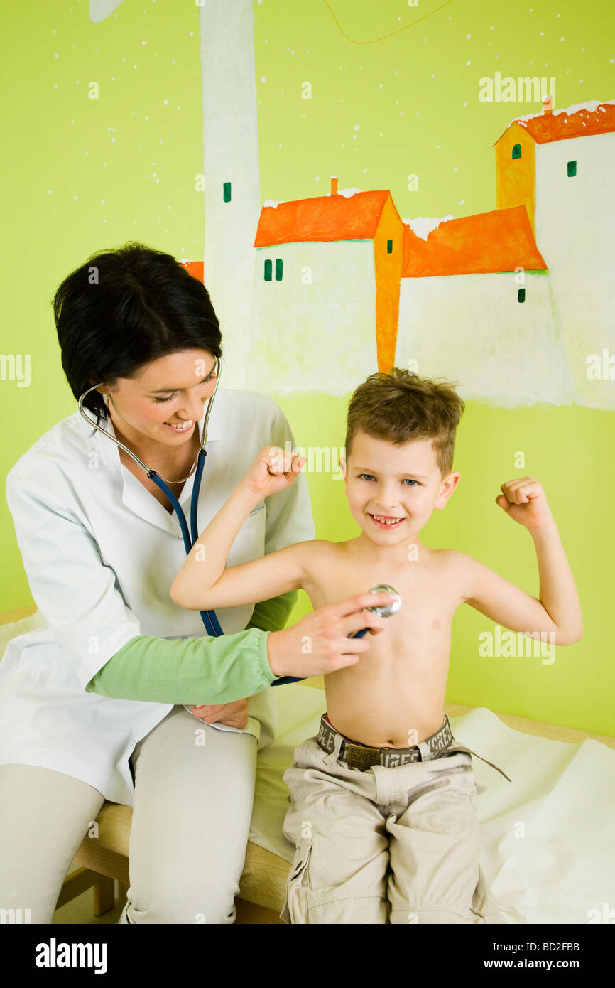 Paediatrician examining boy with stethoscope Stock Photo - Alamy
