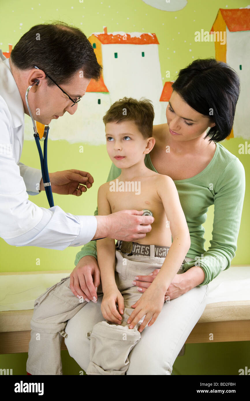 Paediatrician examining boy with stethoscope Stock Photo - Alamy