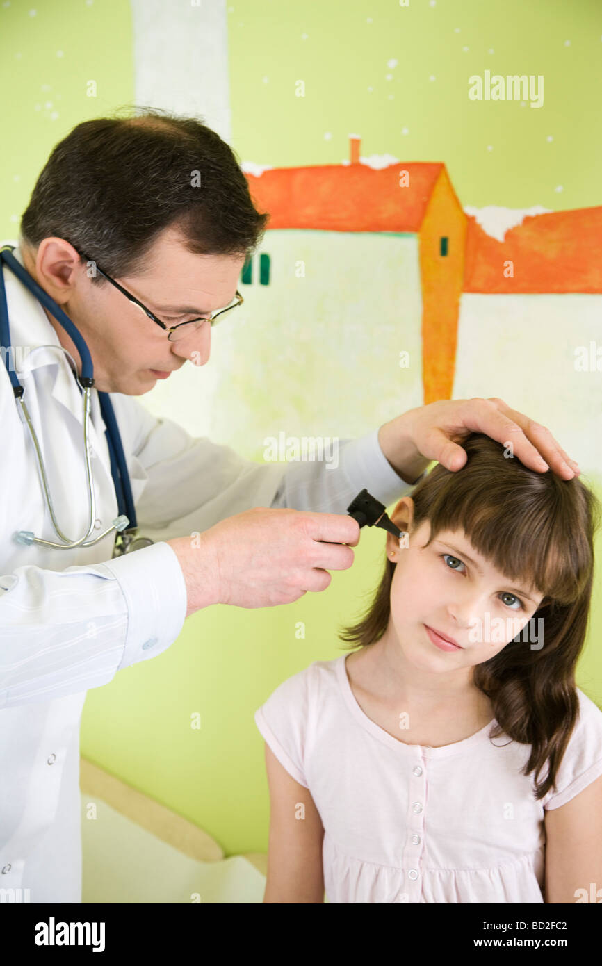 doctor examining child's ear Stock Photo - Alamy