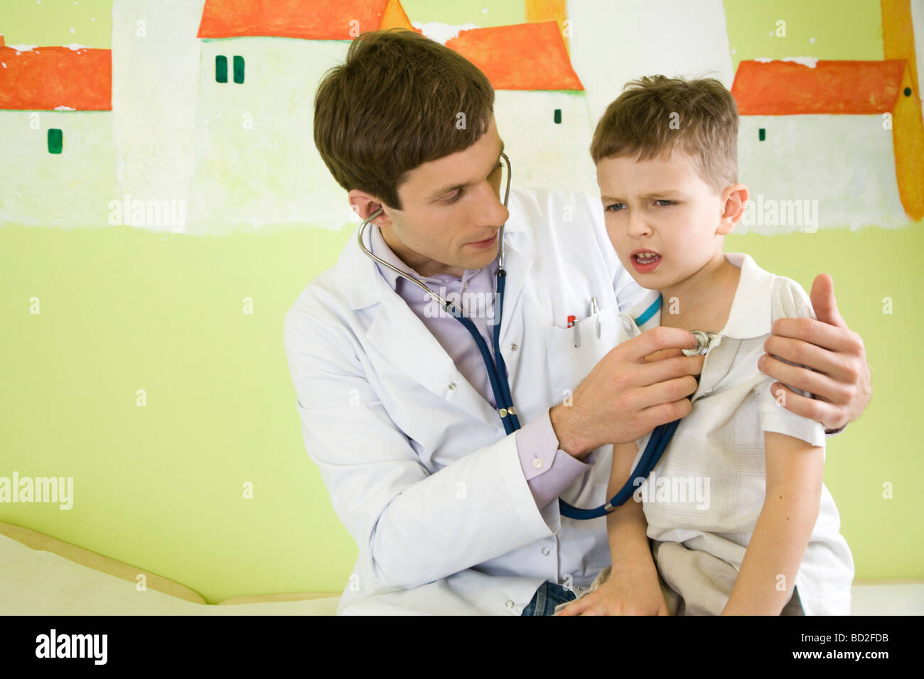 Paediatrician examining boy with stethoscope Stock Photo - Alamy