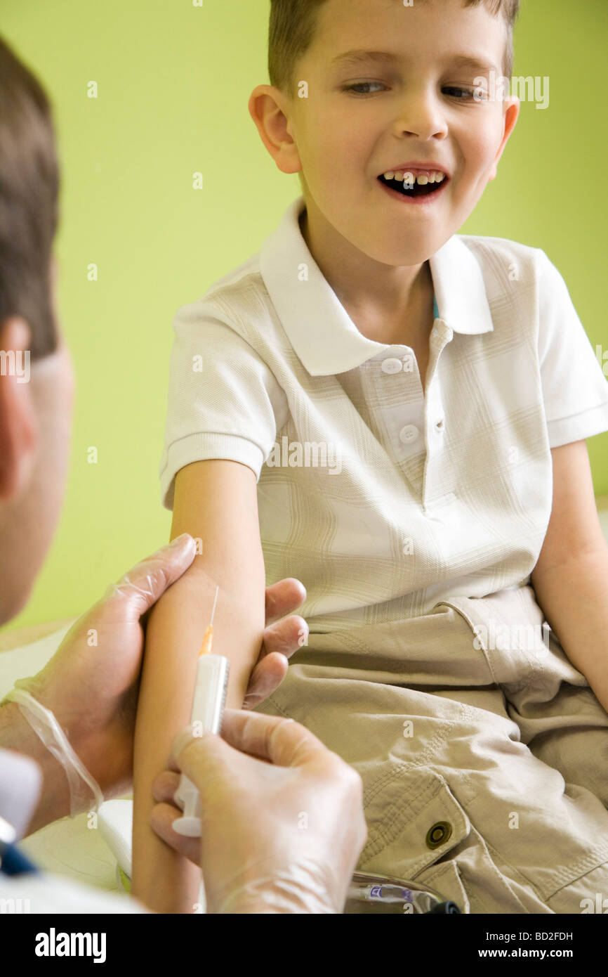 male doctor giving injection to a boy Stock Photo - Alamy