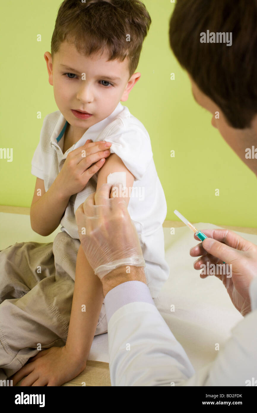 male doctor giving injection to a boy Stock Photo - Alamy