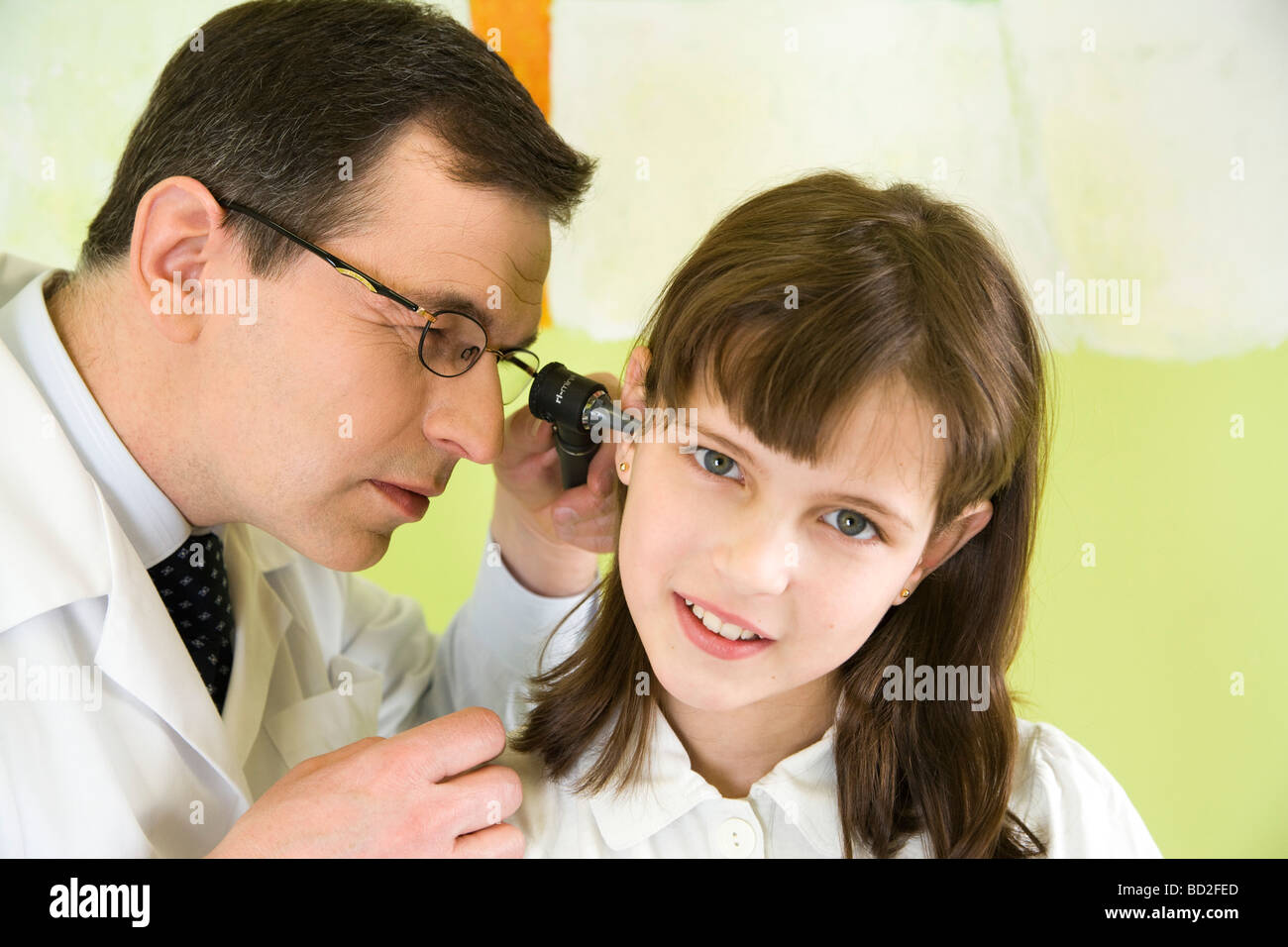 doctor examining child's ear Stock Photo - Alamy