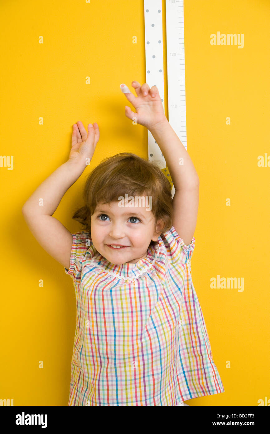 toddler girl measuring height Stock Photo - Alamy