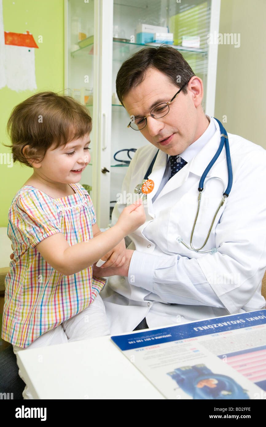 doctor giving lolly pop to toddler girl Stock Photo - Alamy