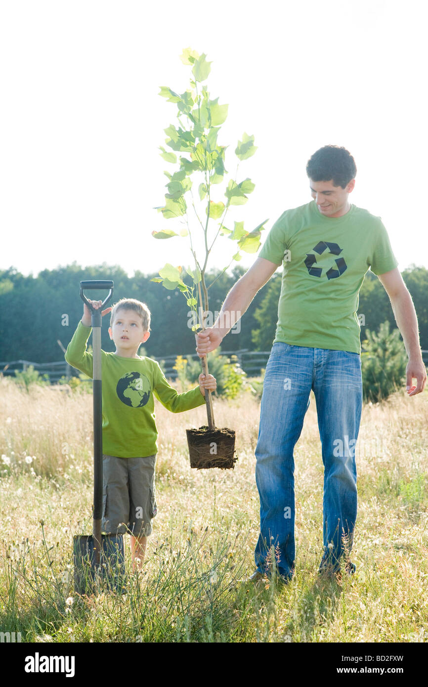 Father and son planting tree Stock Photo - Alamy
