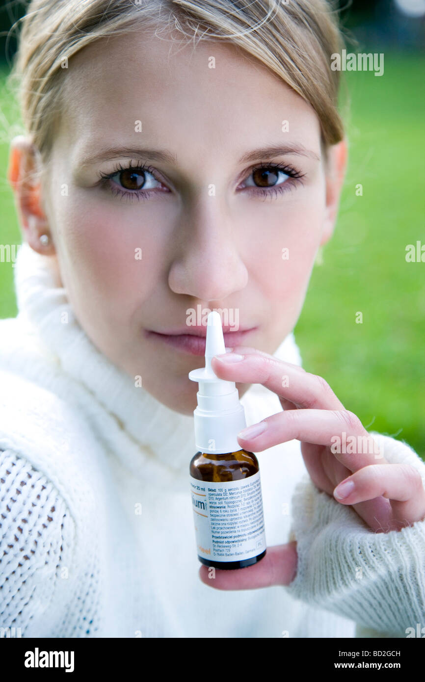young woman applying nose drops Stock Photo - Alamy