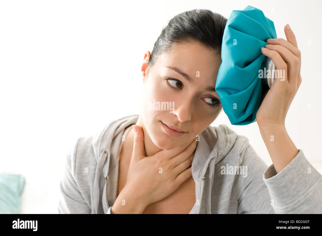 Woman using hot water bottle Stock Photo - Alamy