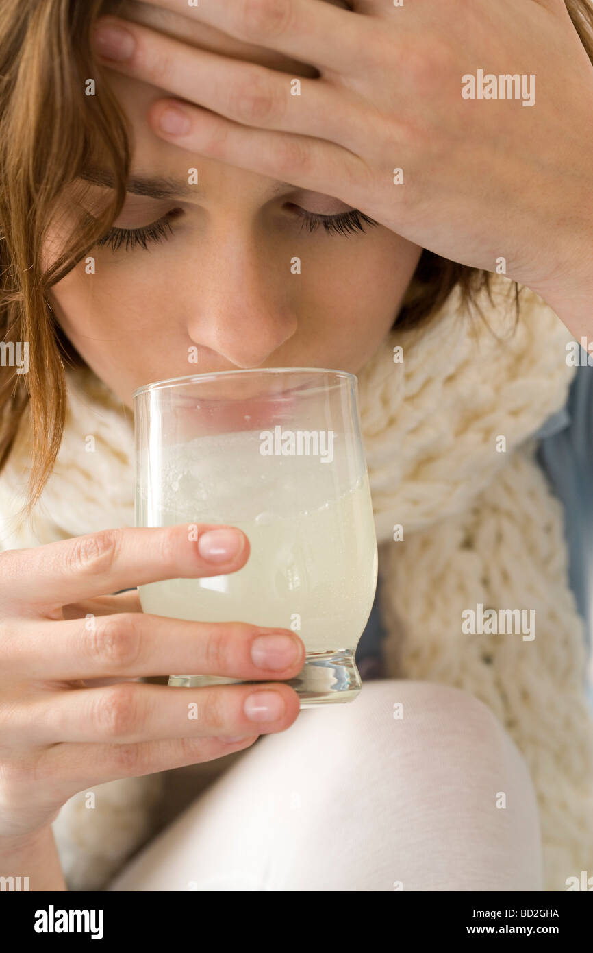 Young woman taking aspirin Stock Photo - Alamy