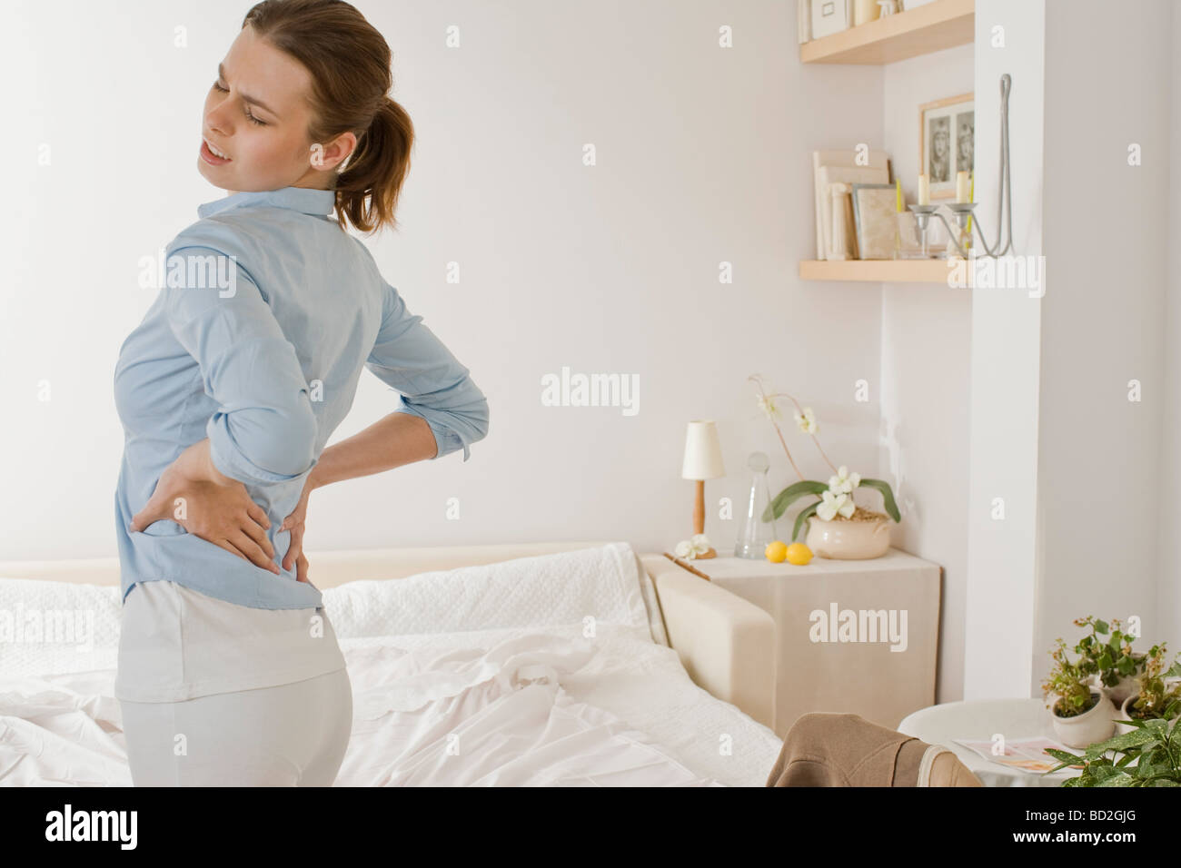 Young woman having backache Stock Photo - Alamy