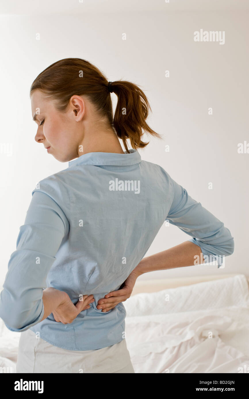 Young woman having backache Stock Photo - Alamy