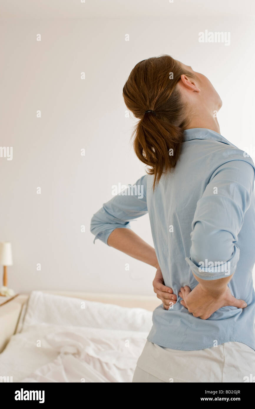 Young woman having backache Stock Photo - Alamy
